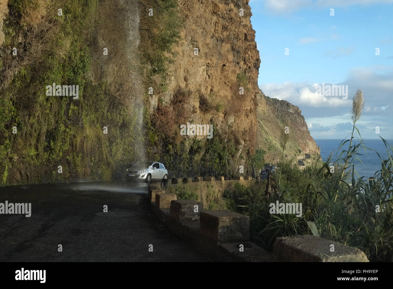 Car passing waterfall Stock Photo - Alamy
