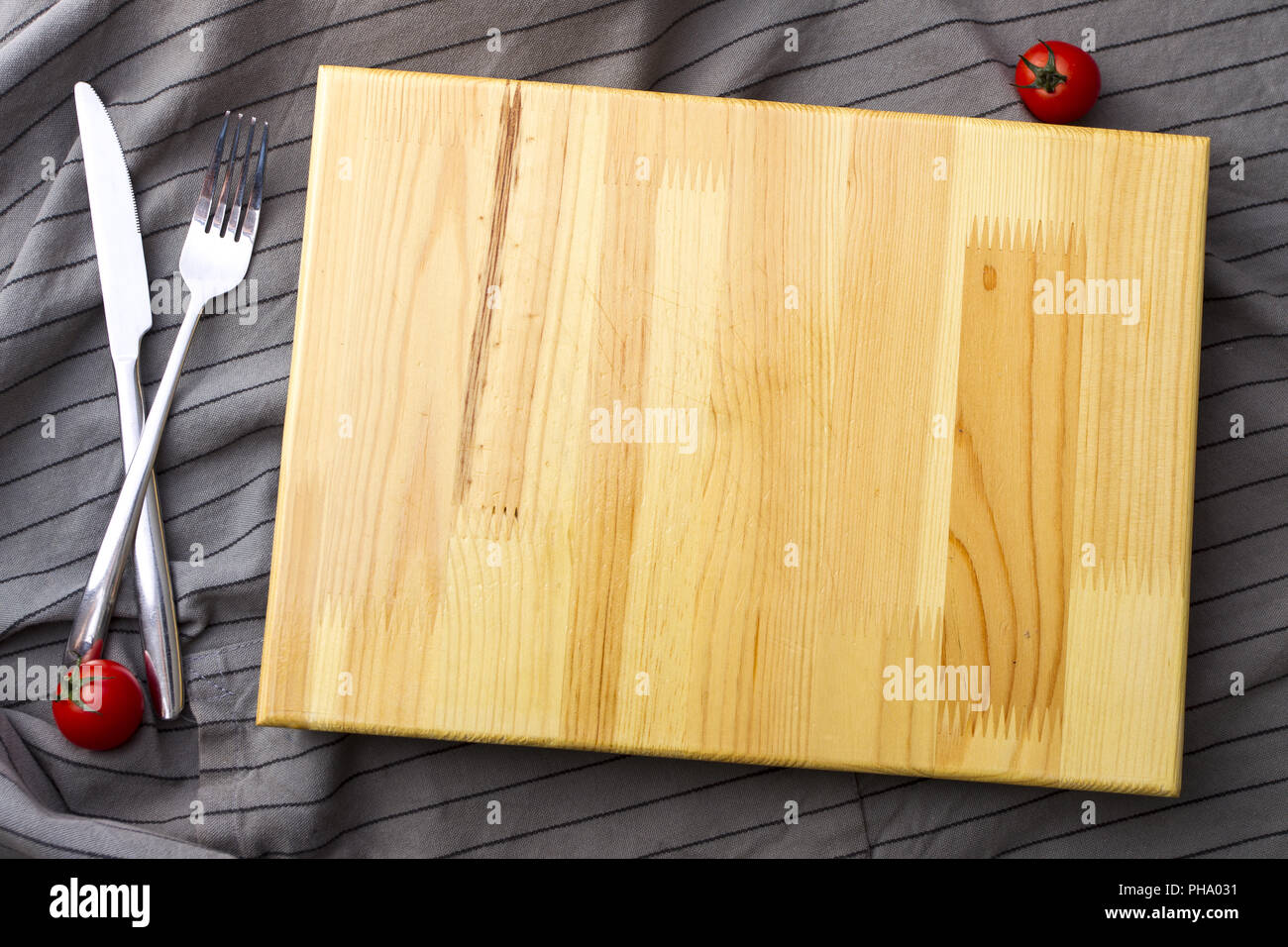 Wooden plate with utensils Stock Photo - Alamy