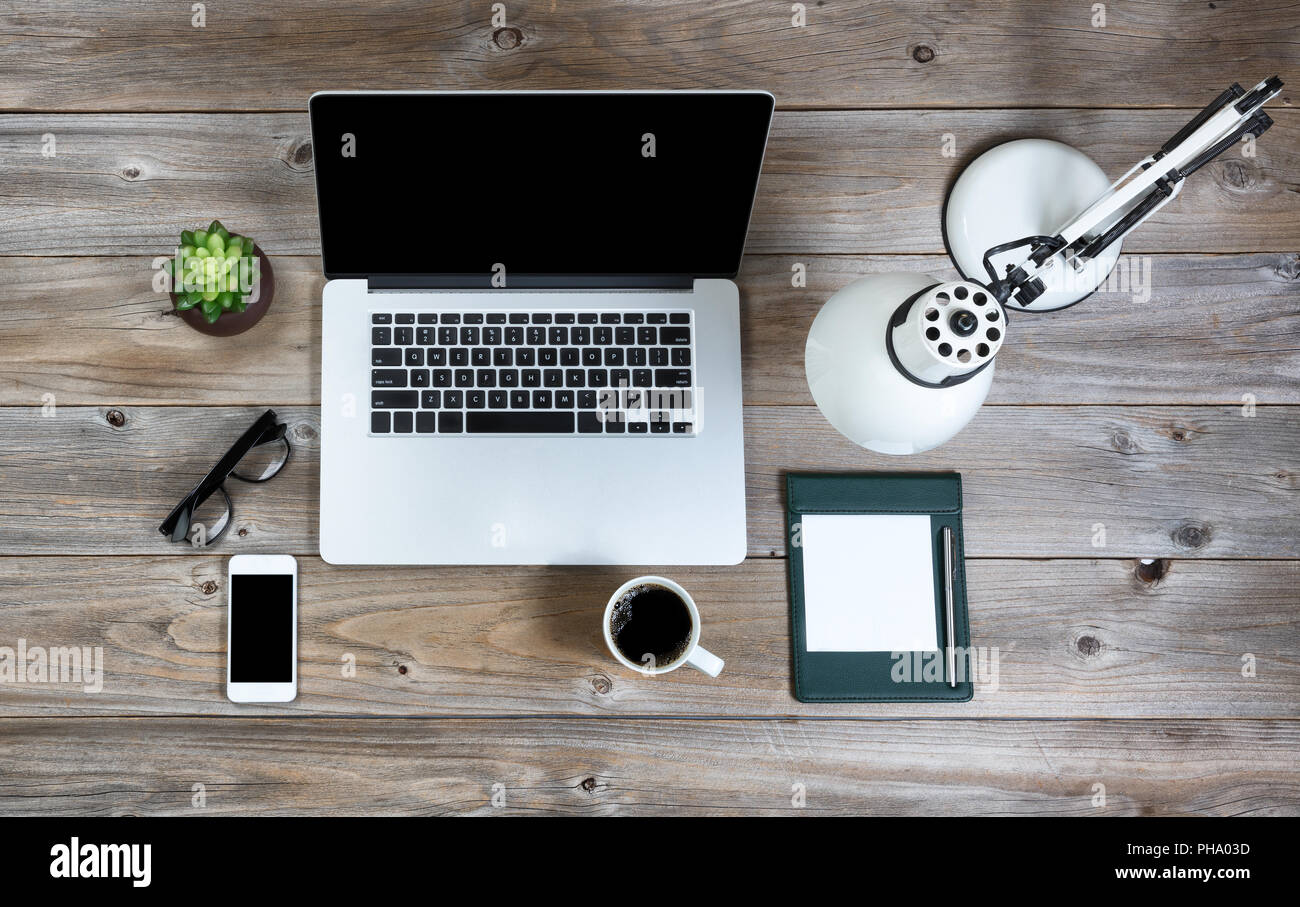 Working desktop in overhead view on rustic wood Stock Photo - Alamy