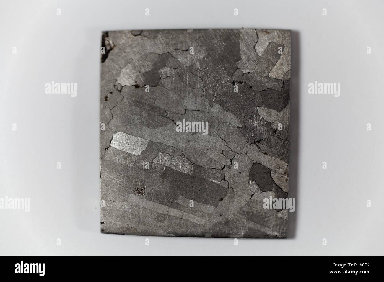 Iron meteorite piece on a white background Stock Photo - Alamy