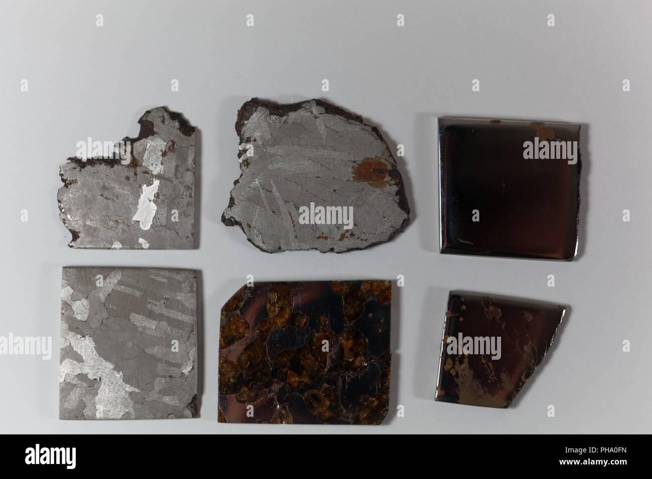 Iron meteorite pieces on a white background Stock Photo - Alamy