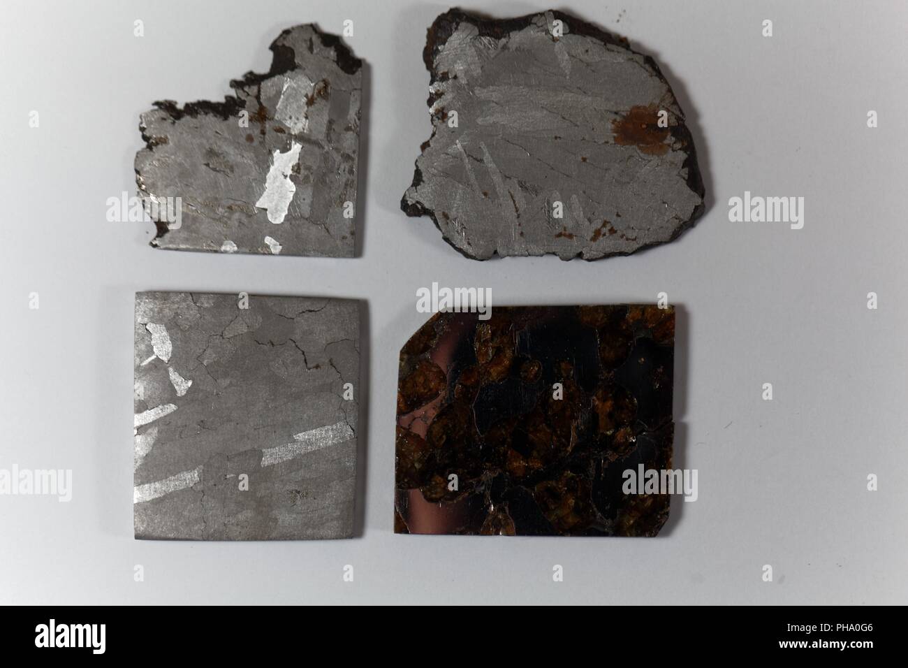 Iron meteorite pieces on a white background Stock Photo - Alamy