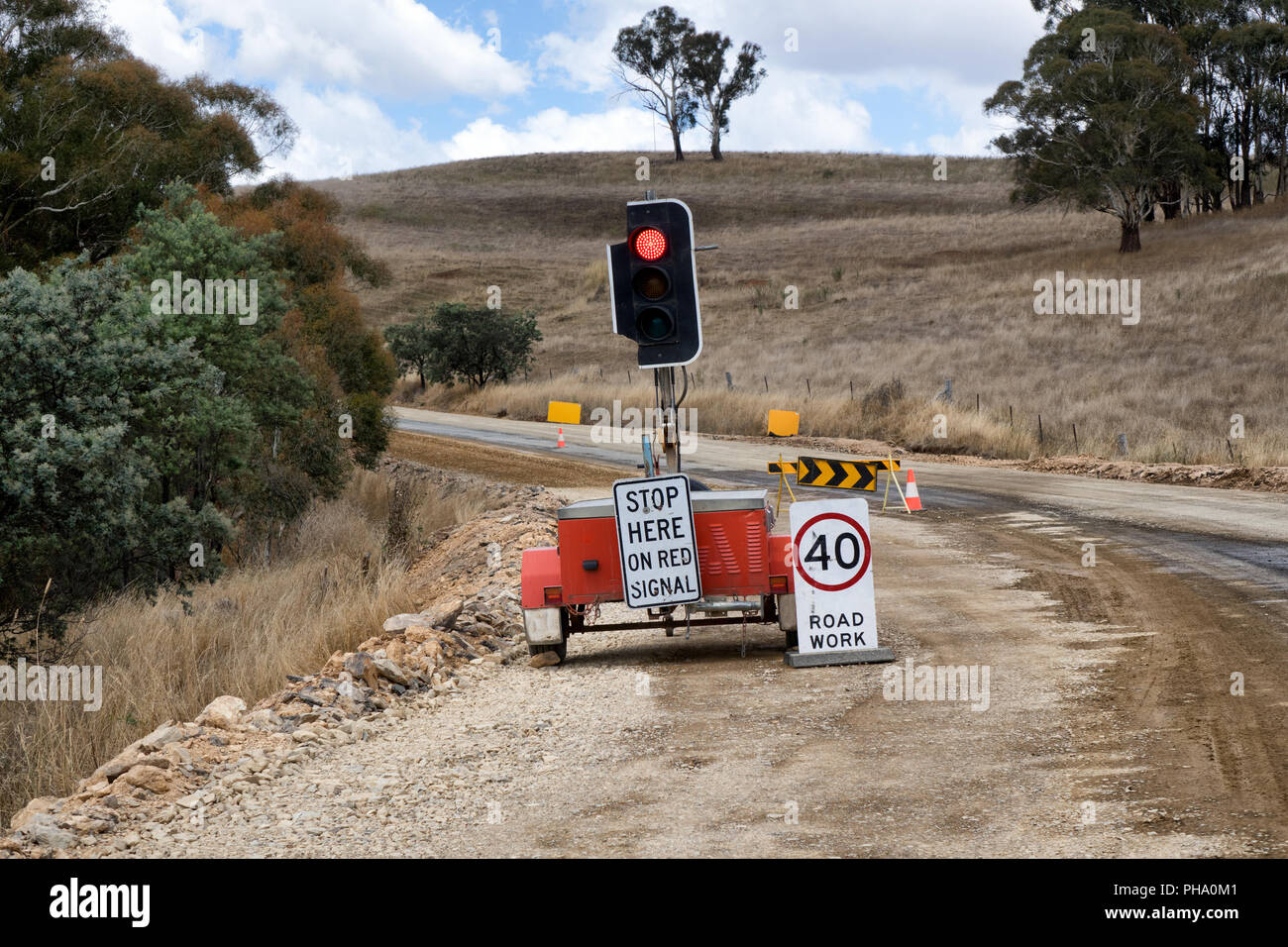 Rural road construction with traffic light and signs Stock Photo - Alamy
