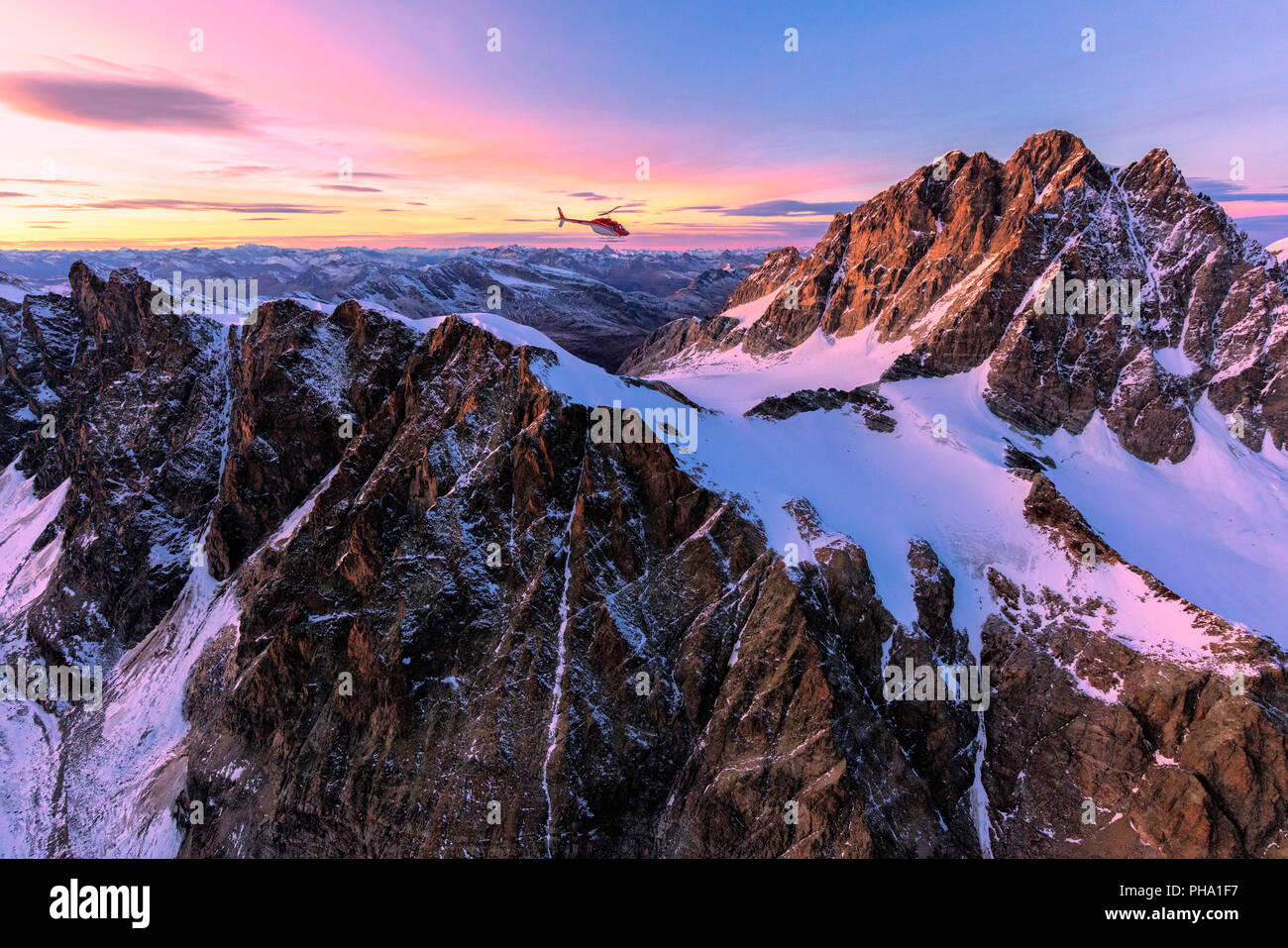 Aerial view of helicopter in flight towards Piz Roseg at sunset ...