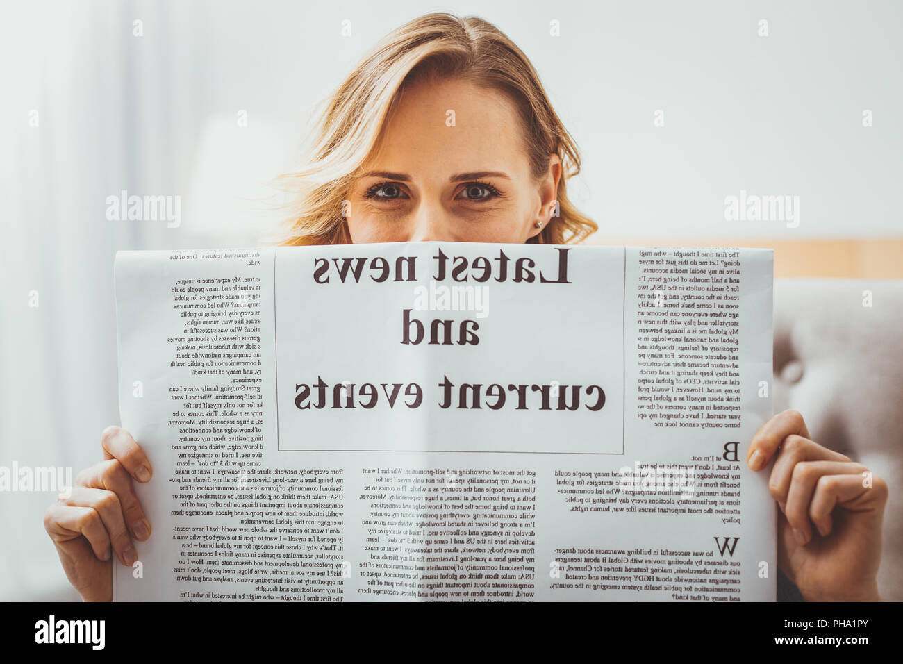 Beautiful young woman demonstrating favorite article Stock Photo - Alamy