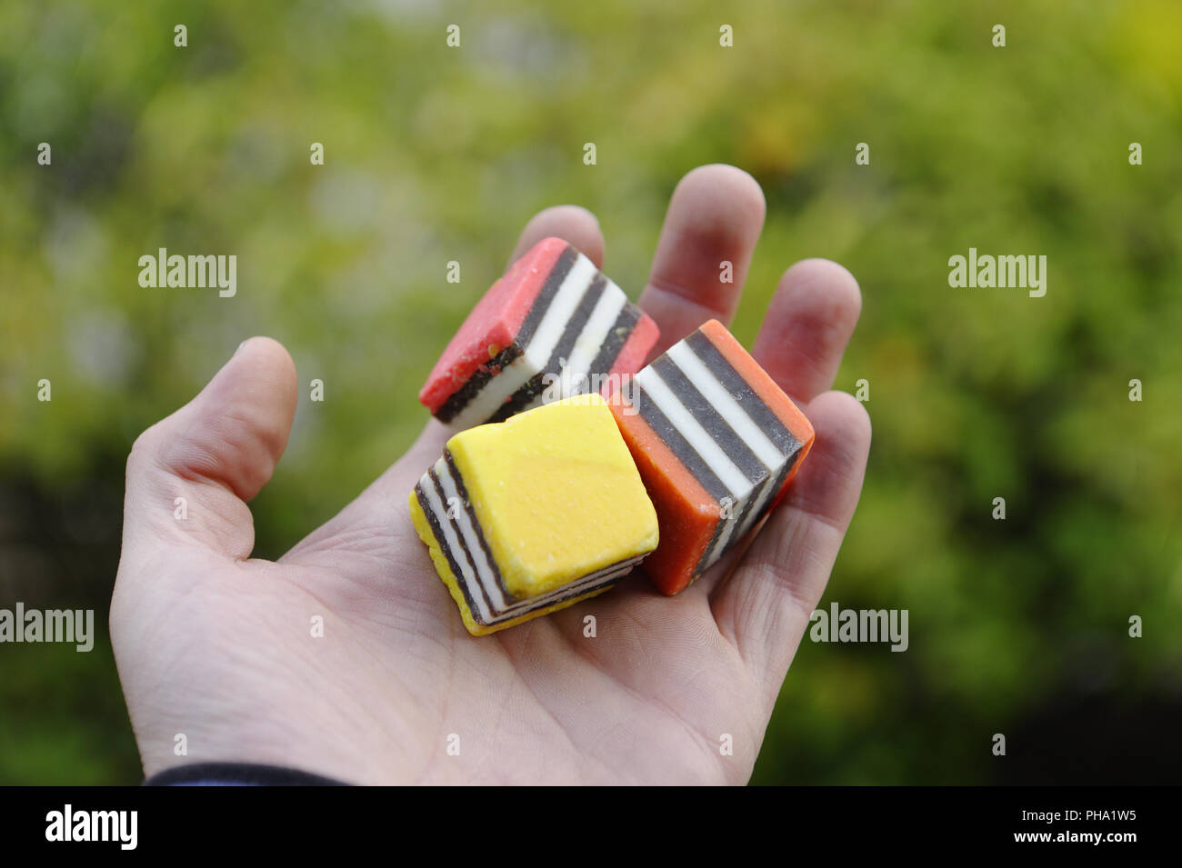 Hand with candy Stock Photo - Alamy