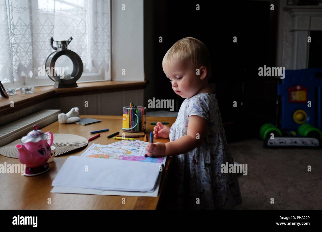 Young female girl child at 20 months old enjoying herself drawing with ...