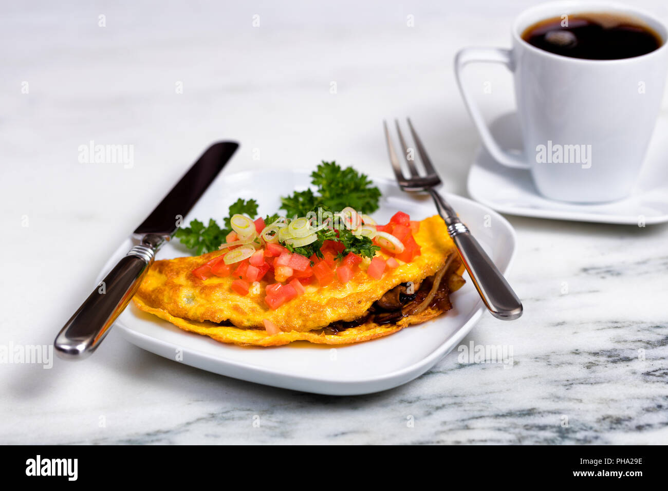 Fresh egg omelet topped with vegetables and coffee for breakfast Stock ...