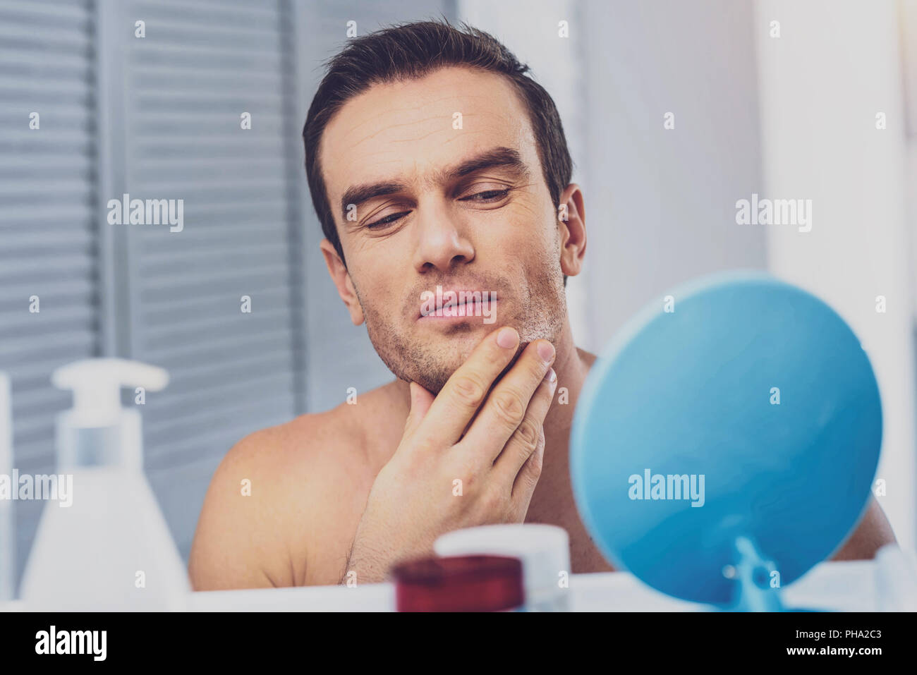 Male model taking care of his skin before photo session Stock Photo - Alamy