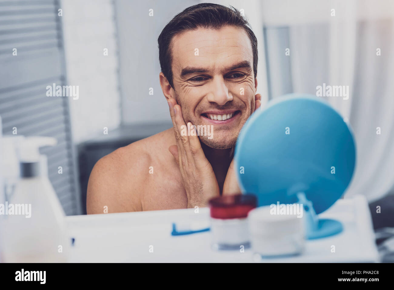 Beaming handsome man washing his face Stock Photo - Alamy
