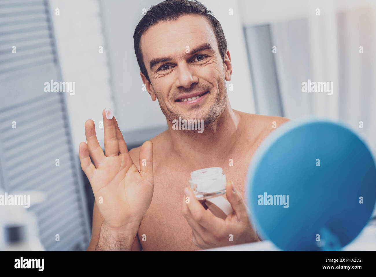 Mature man using cream hi-res stock photography and images - Alamy