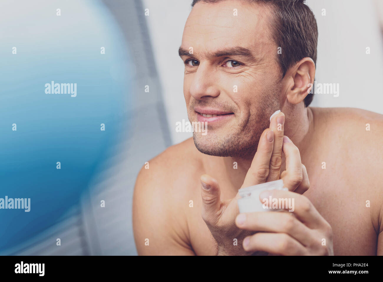 Dark-haired man taking care of his skin Stock Photo - Alamy