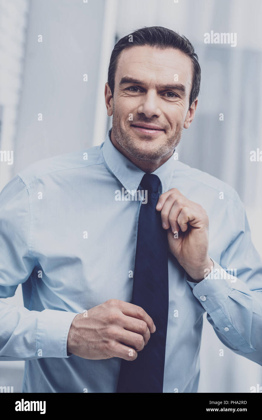 Businessman putting on a tie hi-res stock photography and images - Alamy