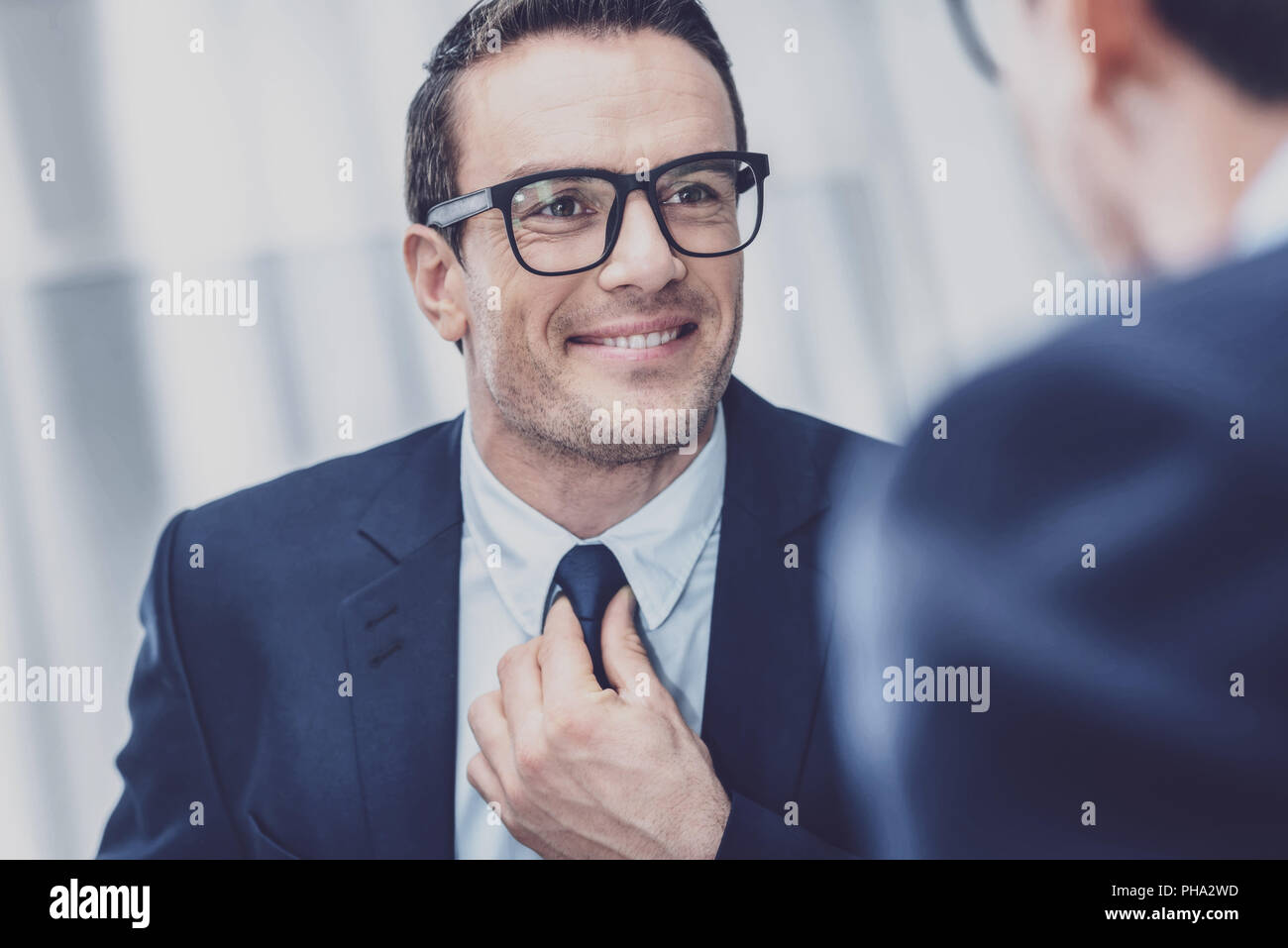 Handsome man looking at mirror Stock Photo - Alamy