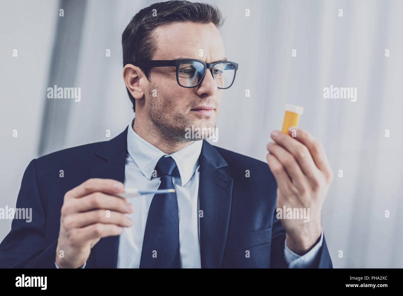Concentrated man reading the tablet instruction Stock Photo - Alamy