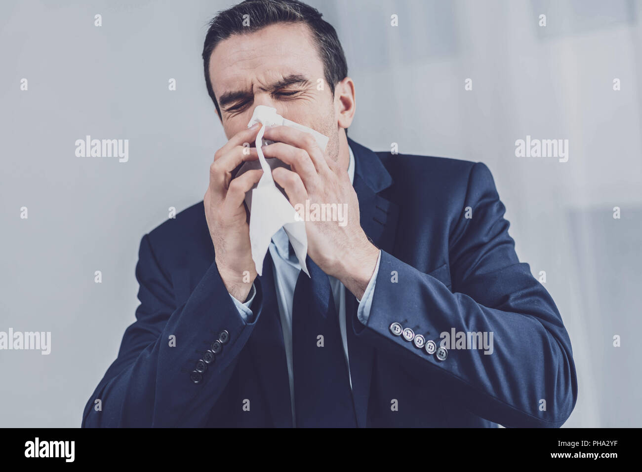 Office worker suffering from cold Stock Photo - Alamy