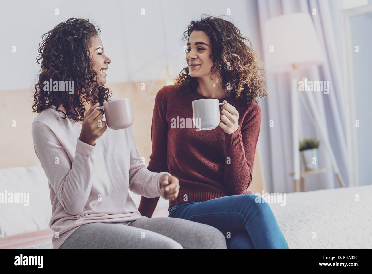 Positive delighted friends having pleasant conversation Stock Photo - Alamy