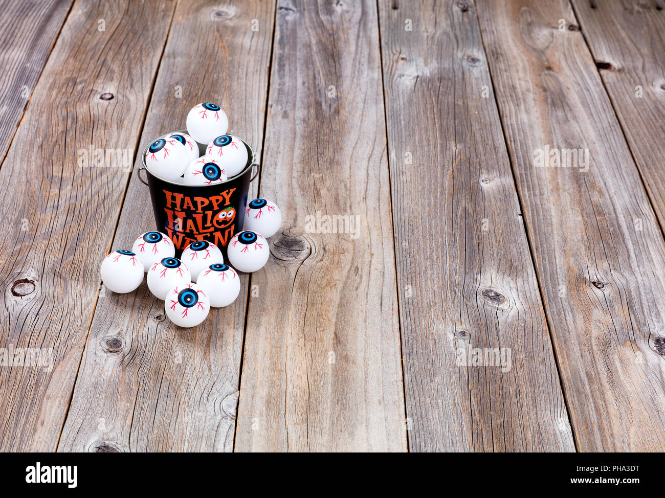 Bucket filled with eyeballs for Halloween season on rustic wood Stock ...