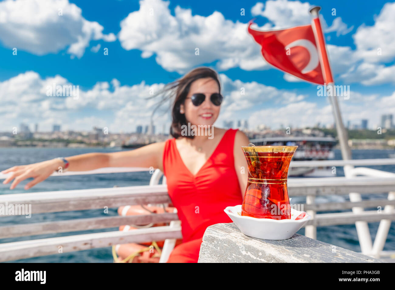 Beautiful Chinese woman cruises on ferry with Turkish flag and tea view ...