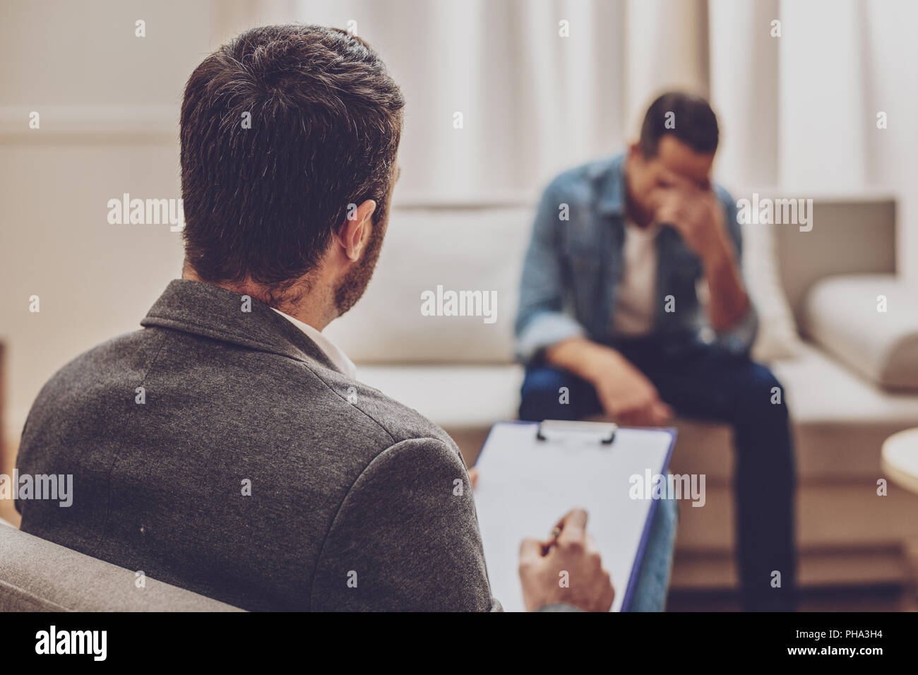 Upset male person being deep in thoughts Stock Photo - Alamy