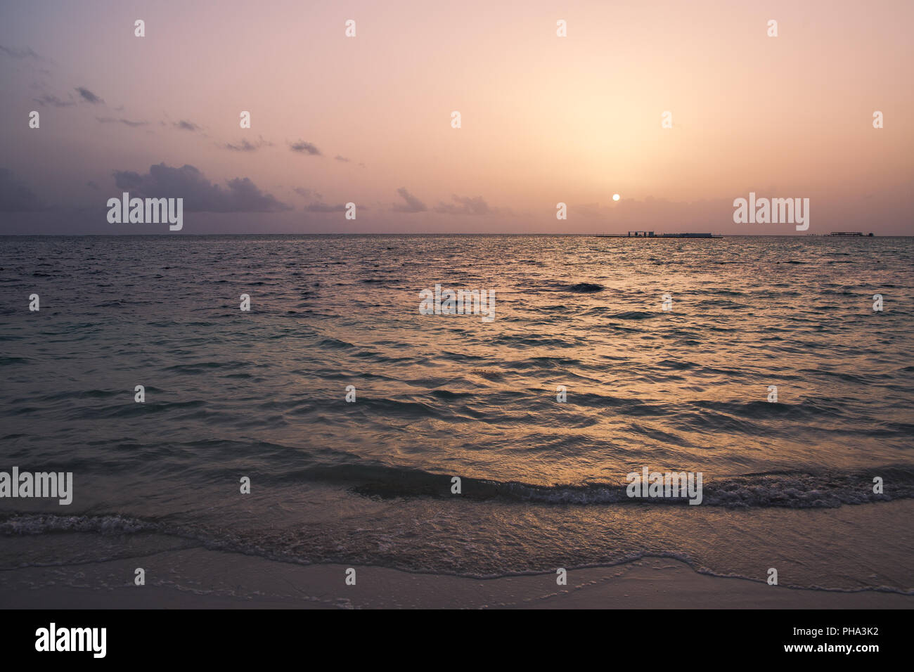Sunrise over water Stock Photo - Alamy