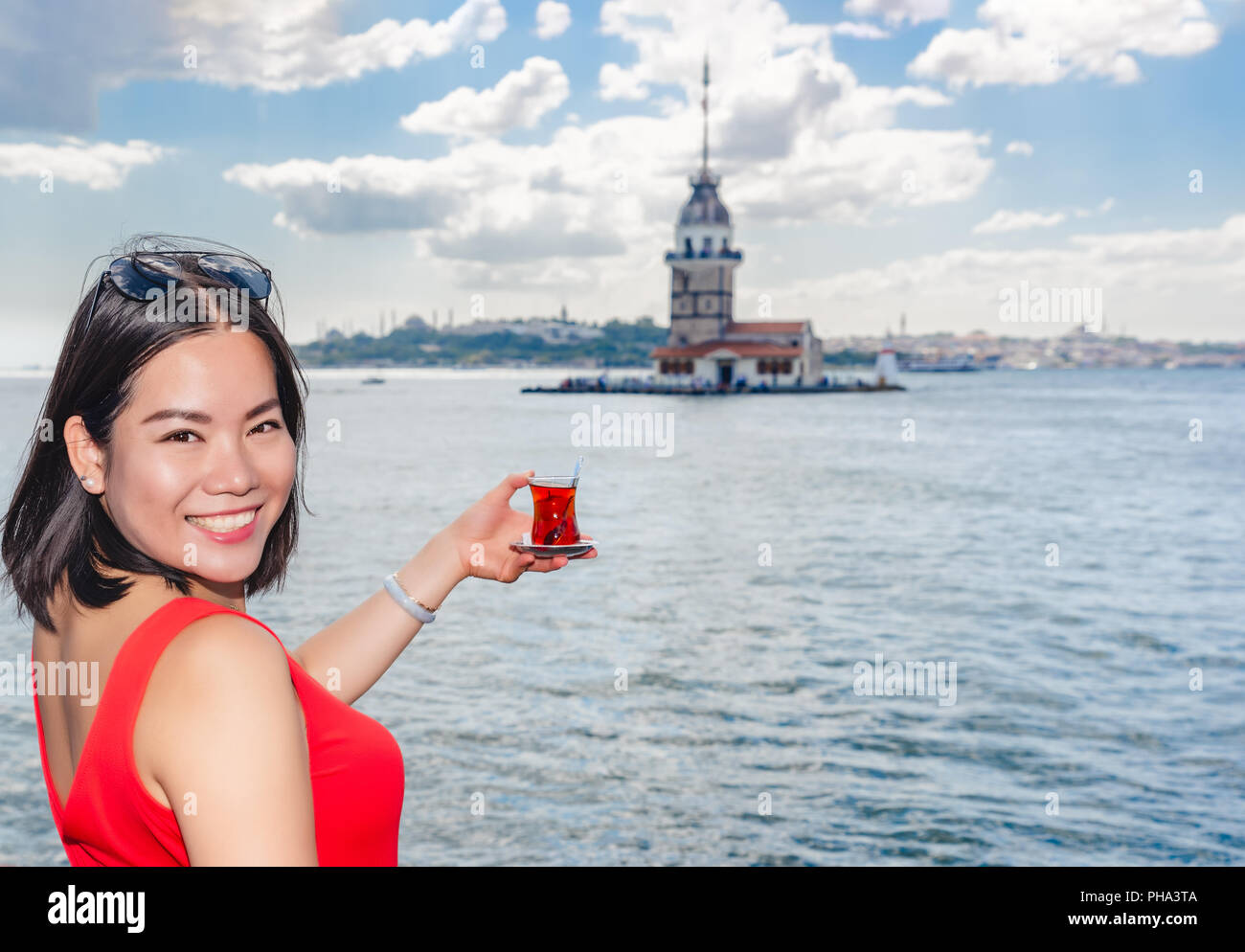 Beautiful Chinese woman holds traditional Turkish tea with Maiden's ...