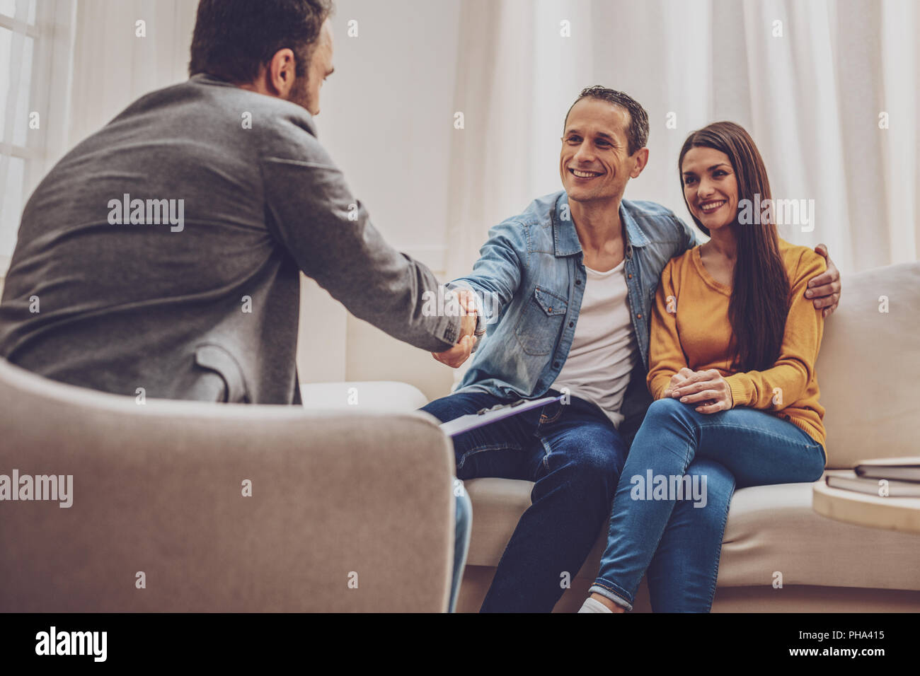 Pleased male person embracing his woman Stock Photo - Alamy