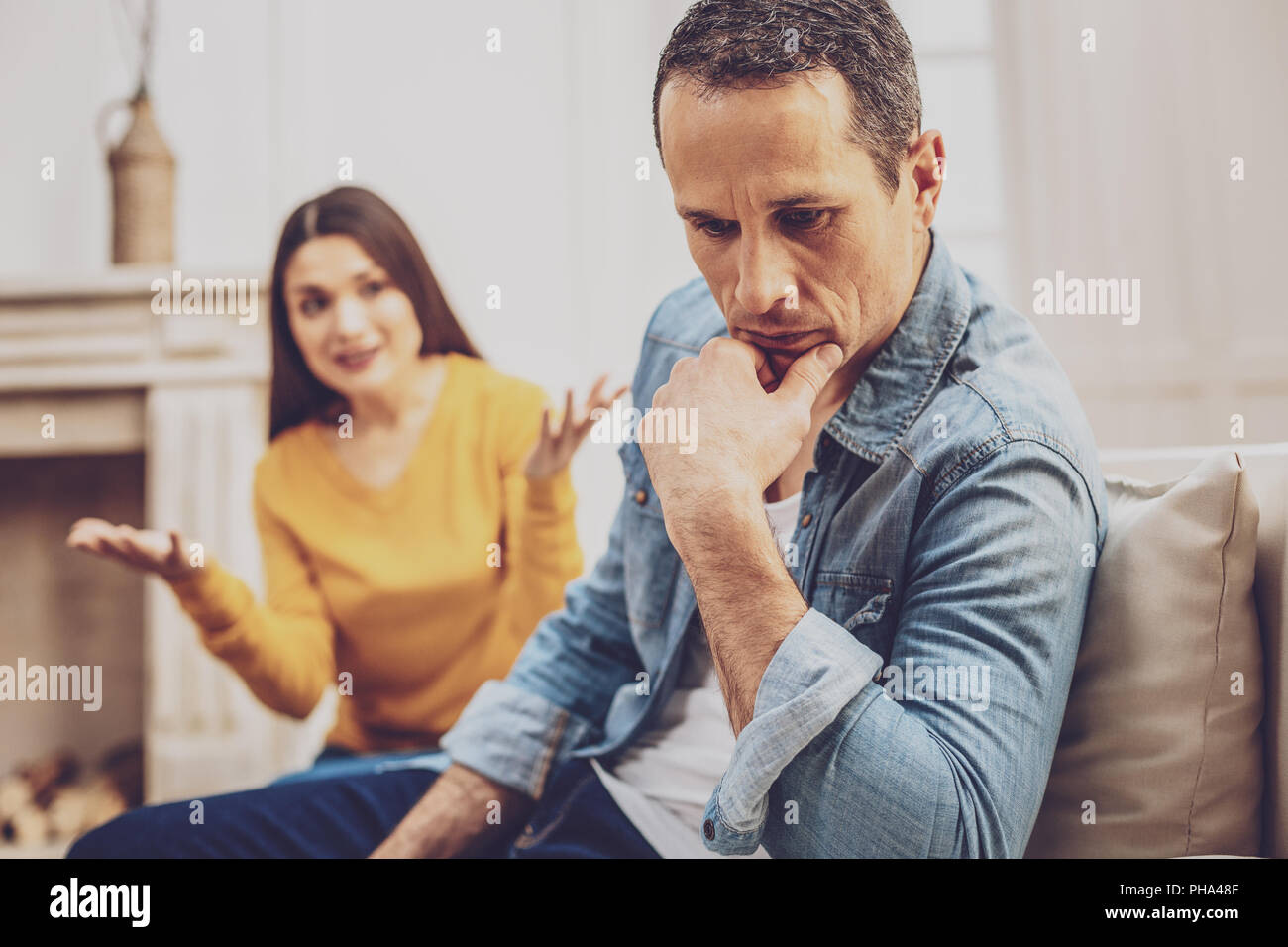 Upset young man being deep in thoughts Stock Photo - Alamy