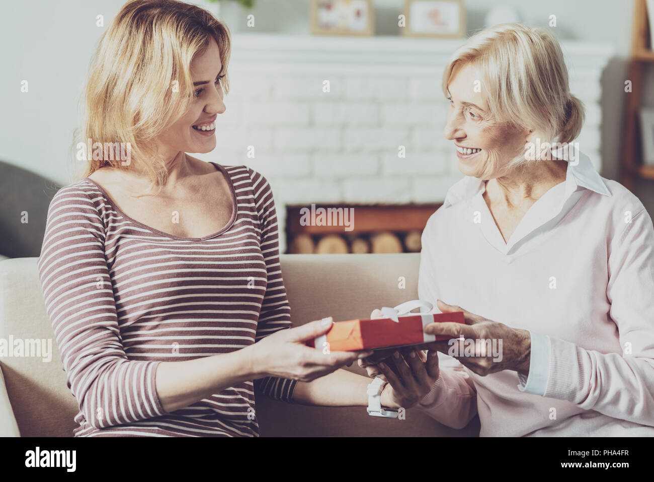 Nice young woman giving a gift Stock Photo - Alamy