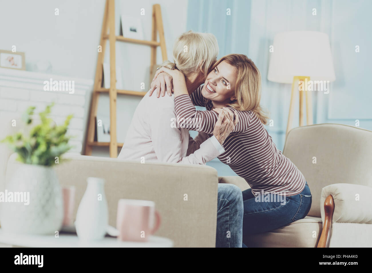Delighted nice woman hugging her mother Stock Photo - Alamy