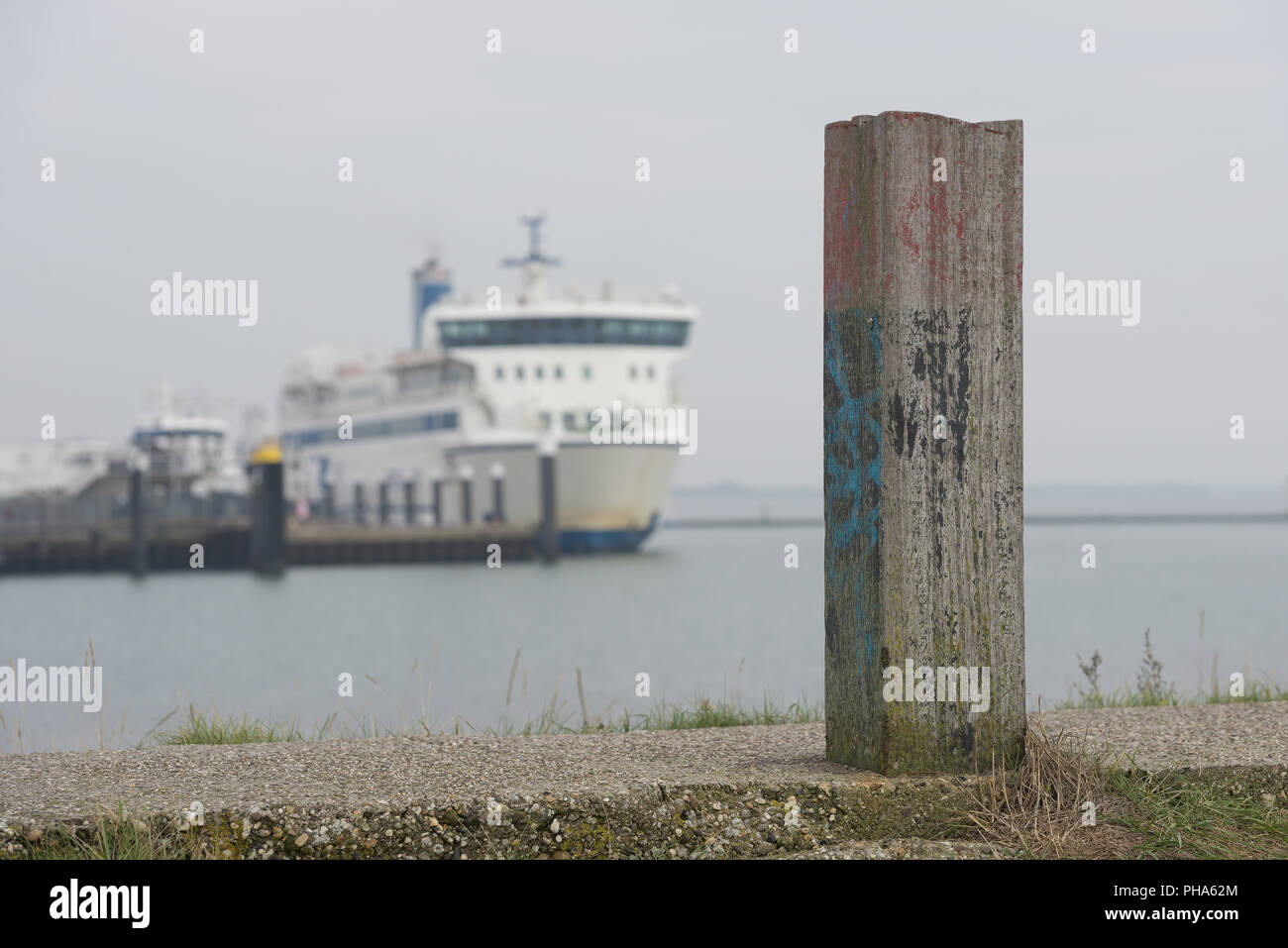Bollard on the embankment of the port of West Terschelling Stock Photo ...