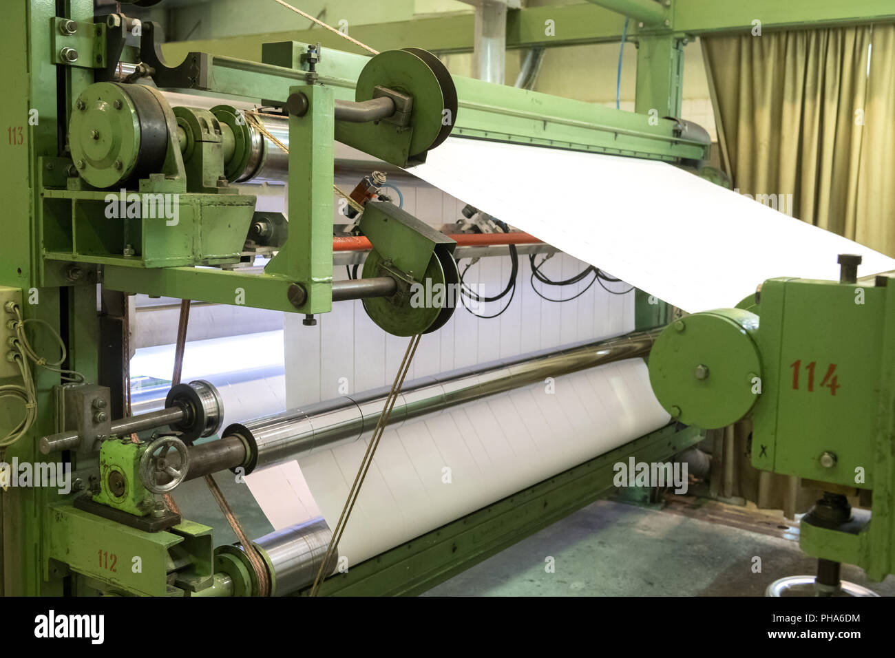 A roll of paper installed in a typographic machine Stock Photo - Alamy