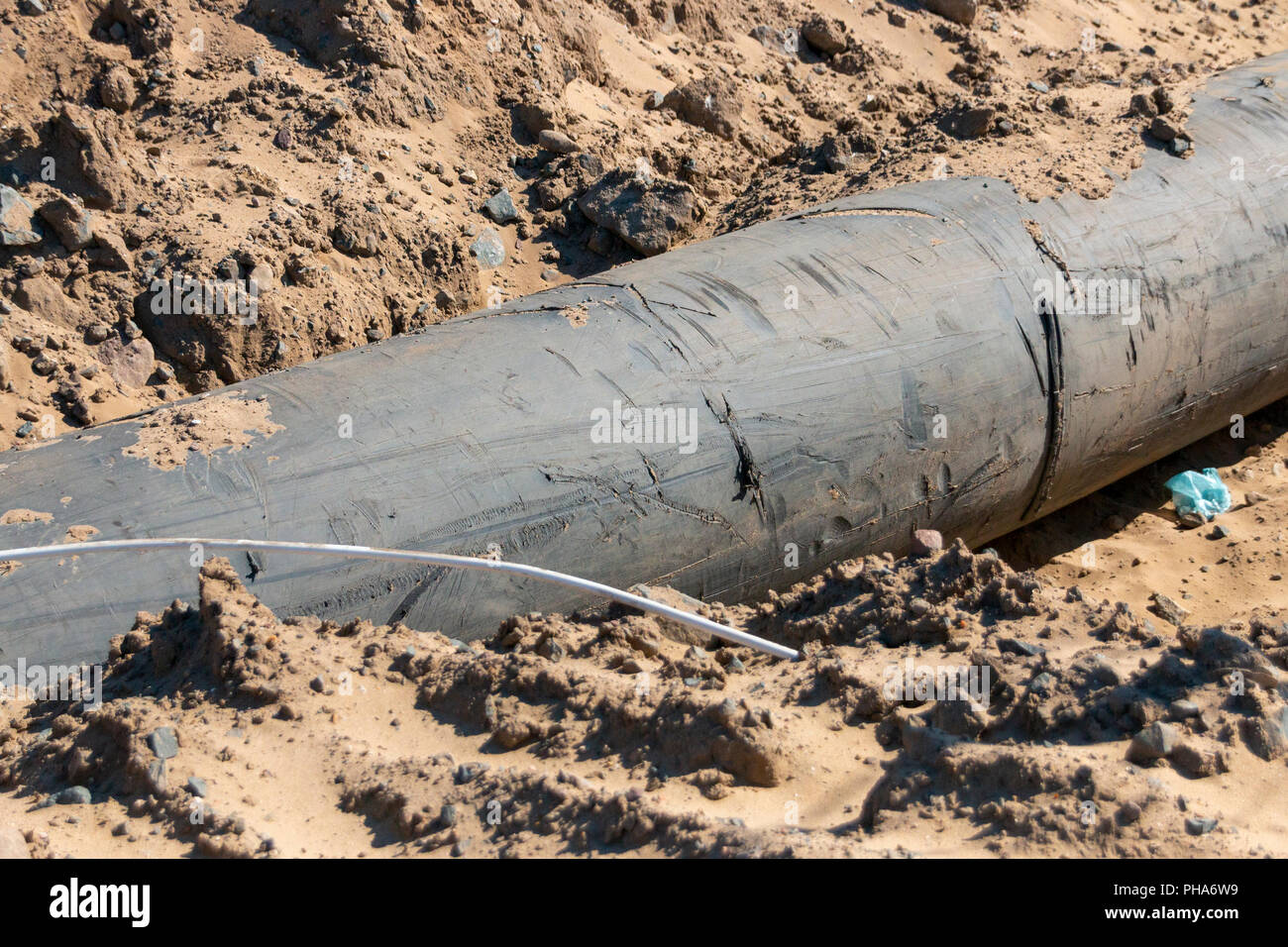 A close up view of plastic pipes under the sea sand on the beach Stock ...