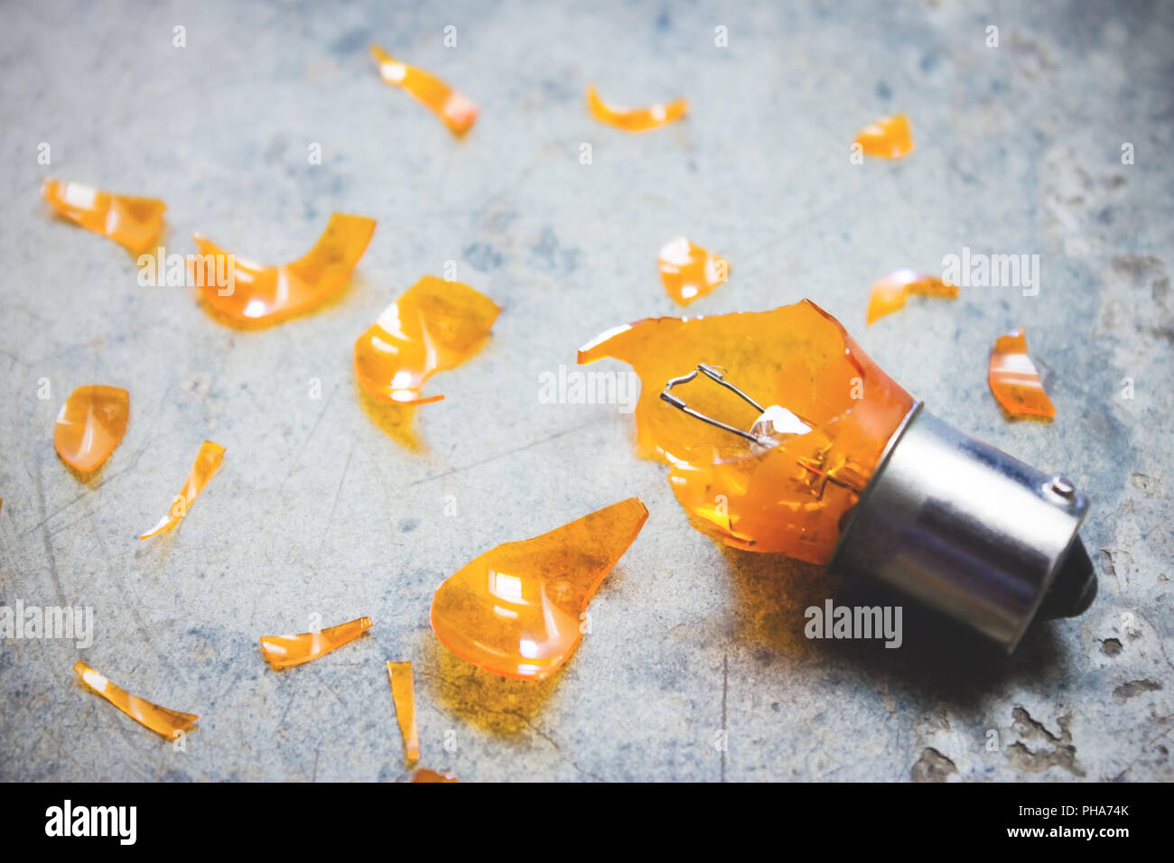 Automotive light bulb in broken condition and sharp glass shards ...