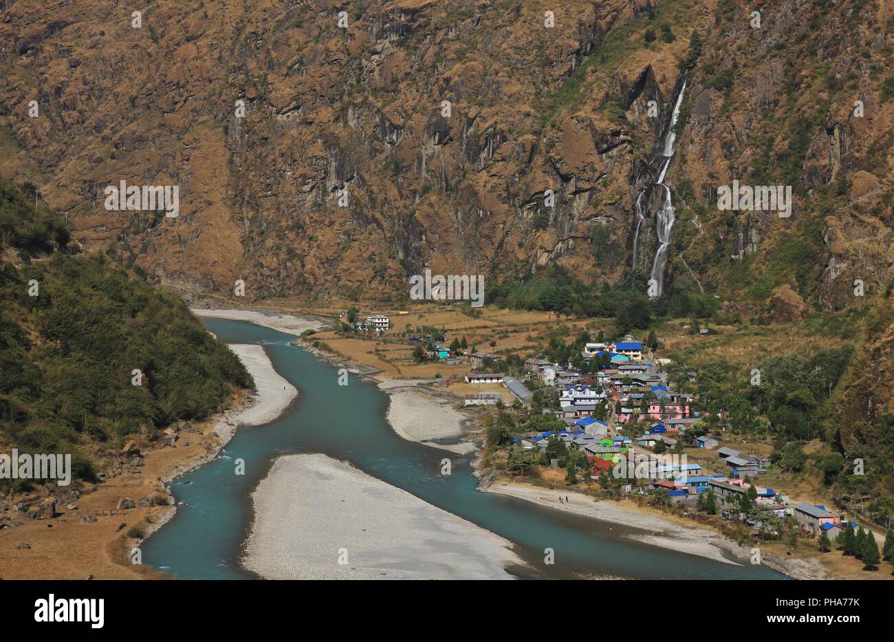 Colorful village Tal, waterfall and Marsyangdi river Stock Photo - Alamy