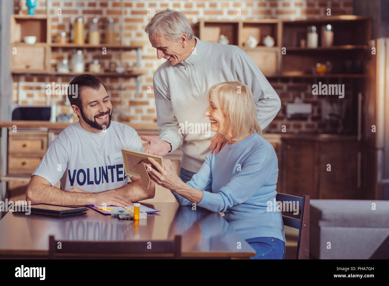 Senior interested man standing and talking to a volunteer Stock Photo ...