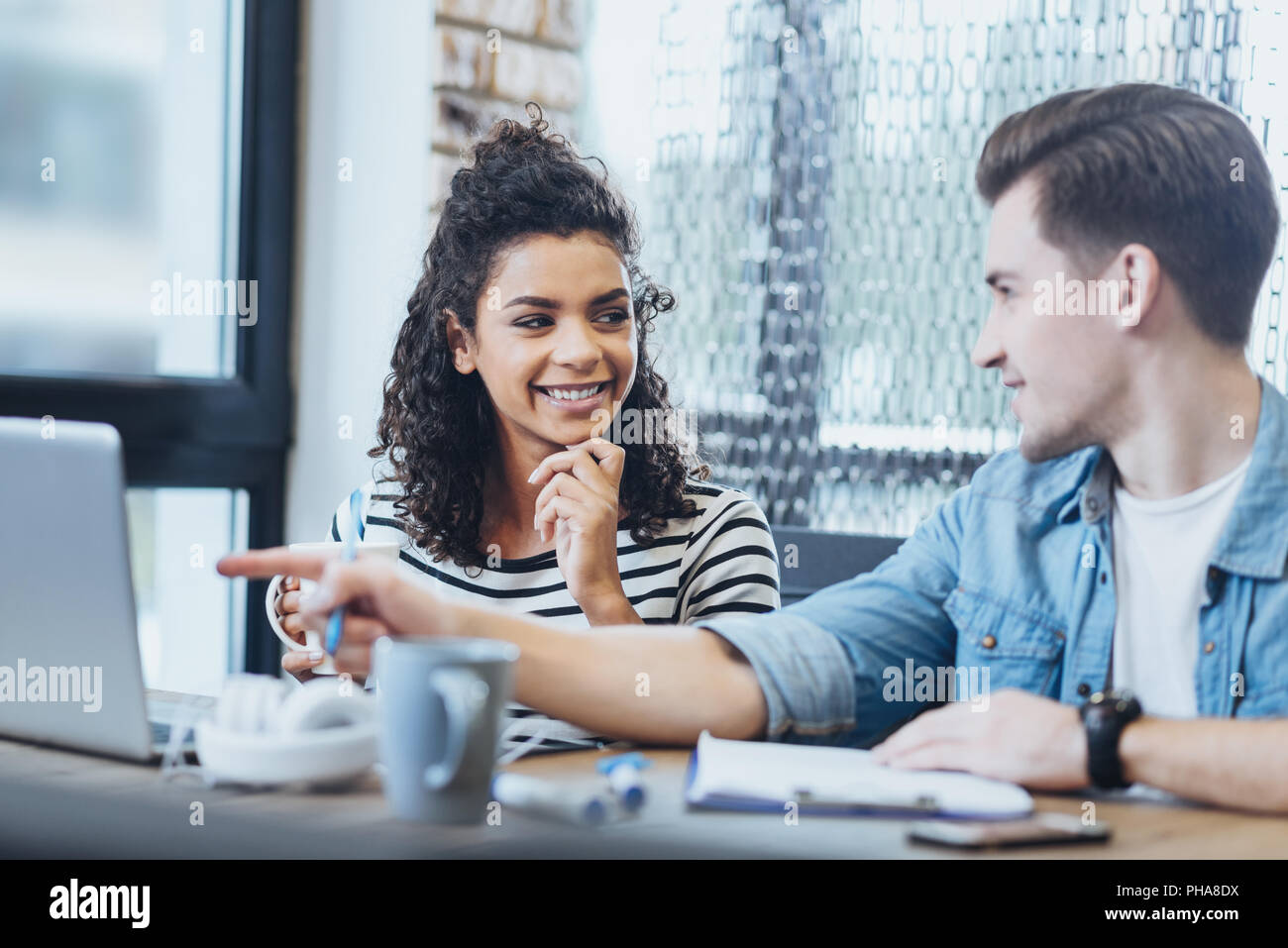 Merry two students completing assignment Stock Photo - Alamy