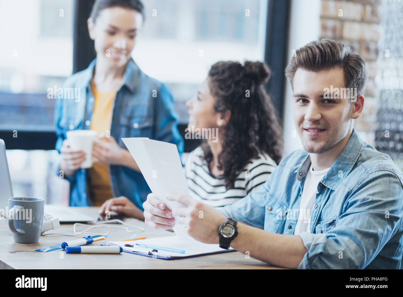 Handsome male student preparing task Stock Photo - Alamy