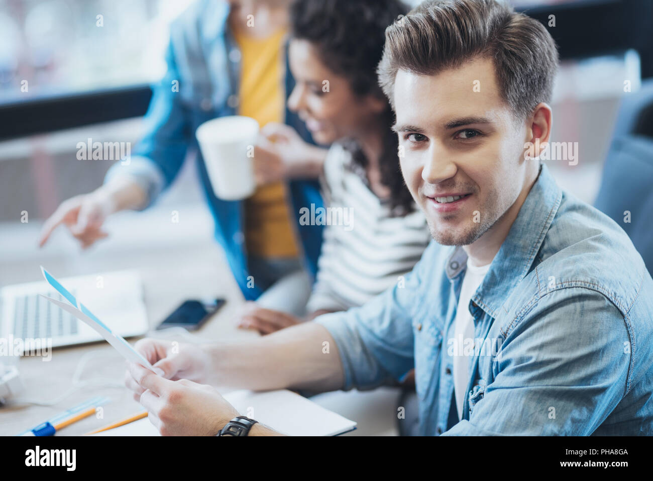 Charming male student coming up with idea Stock Photo - Alamy
