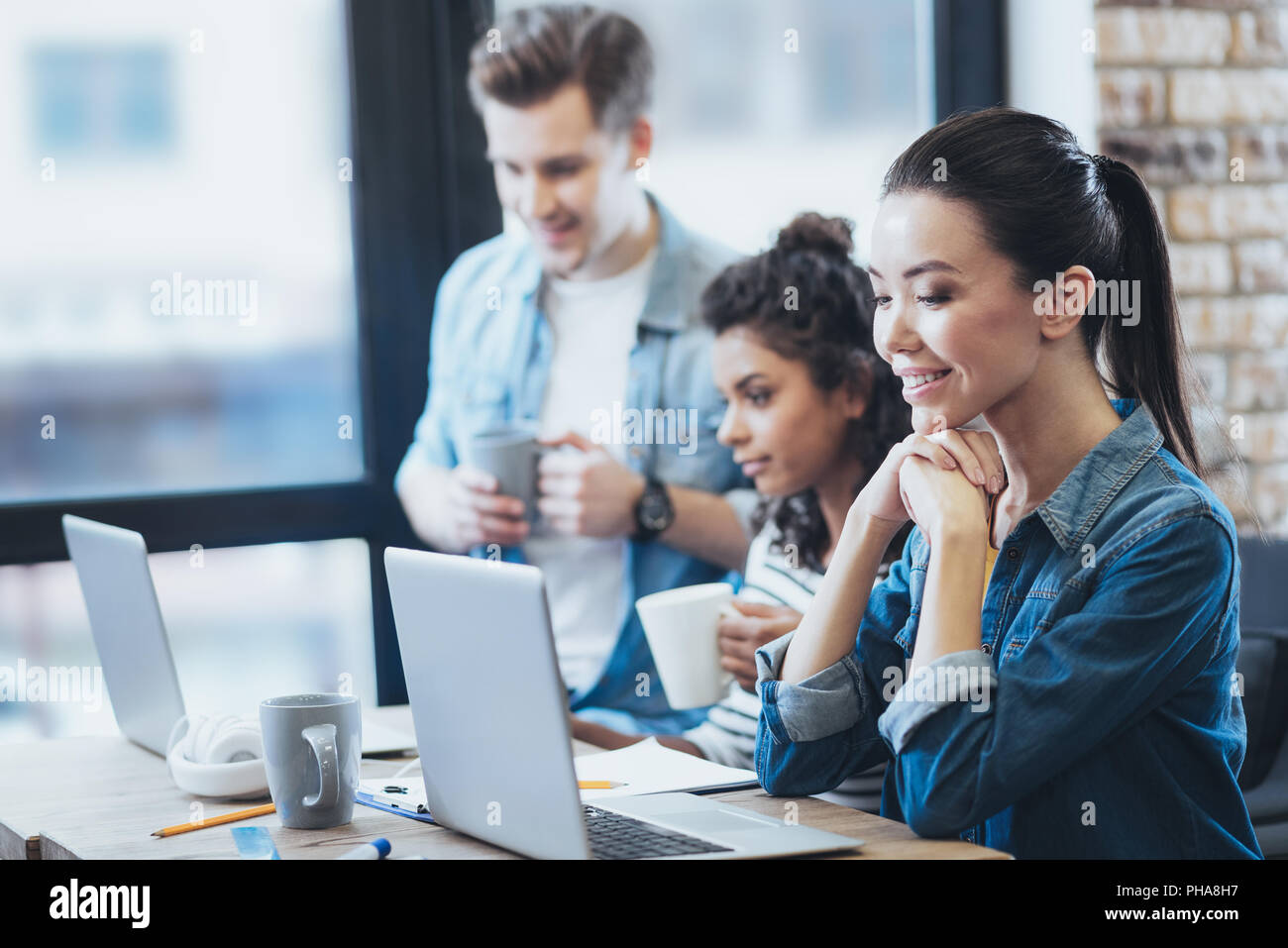 Thoughtful three students creating plan Stock Photo - Alamy