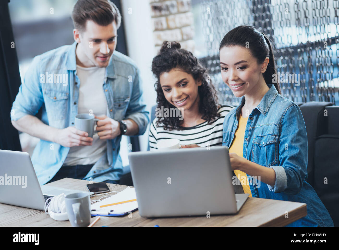 Happy three students discussing ideas Stock Photo - Alamy