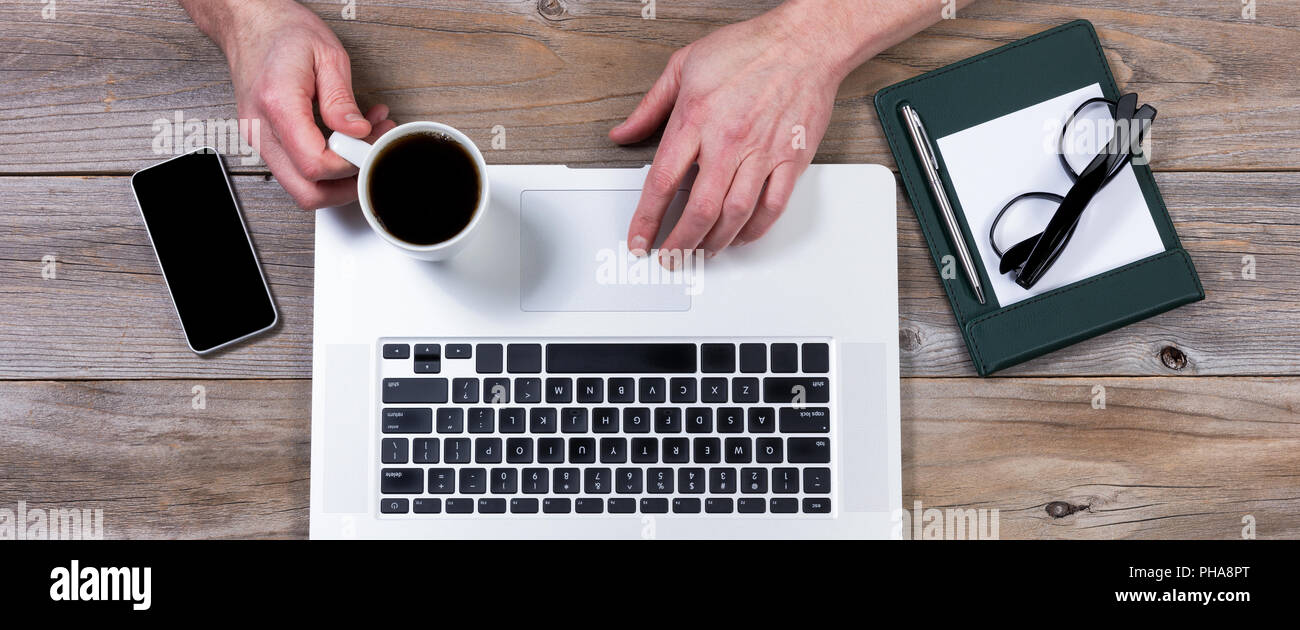 Overhead view of working desktop with hands on laptop Stock Photo - Alamy