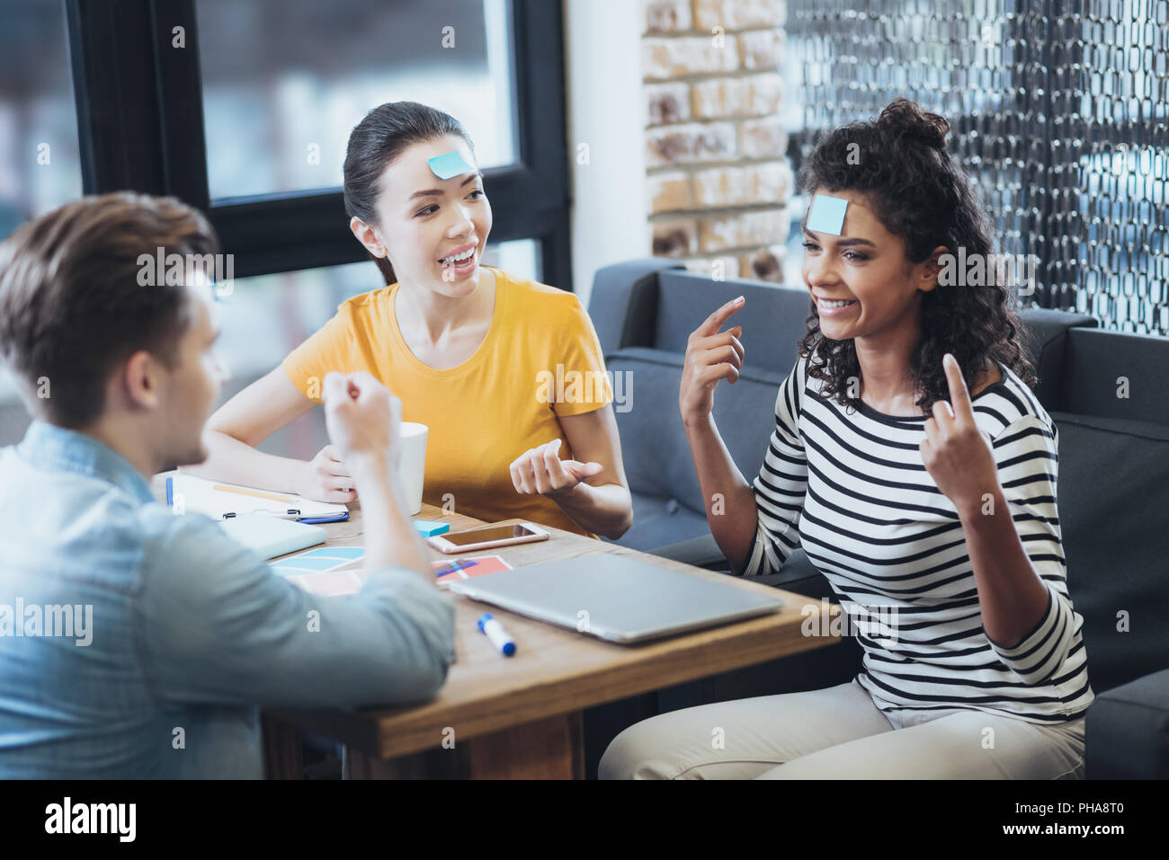 Positive three friends playing game Stock Photo - Alamy