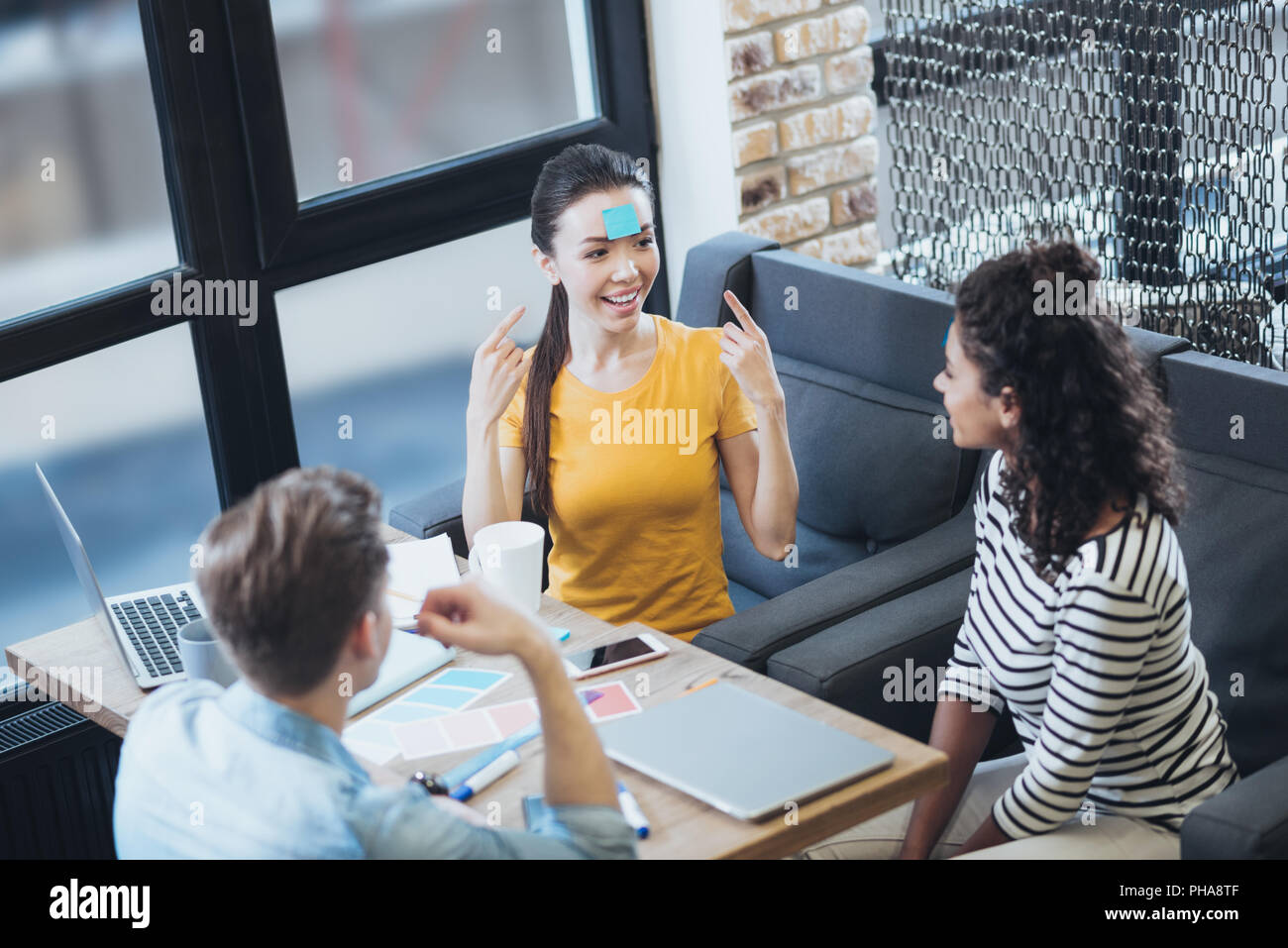 Young three friends playing at cafe Stock Photo - Alamy