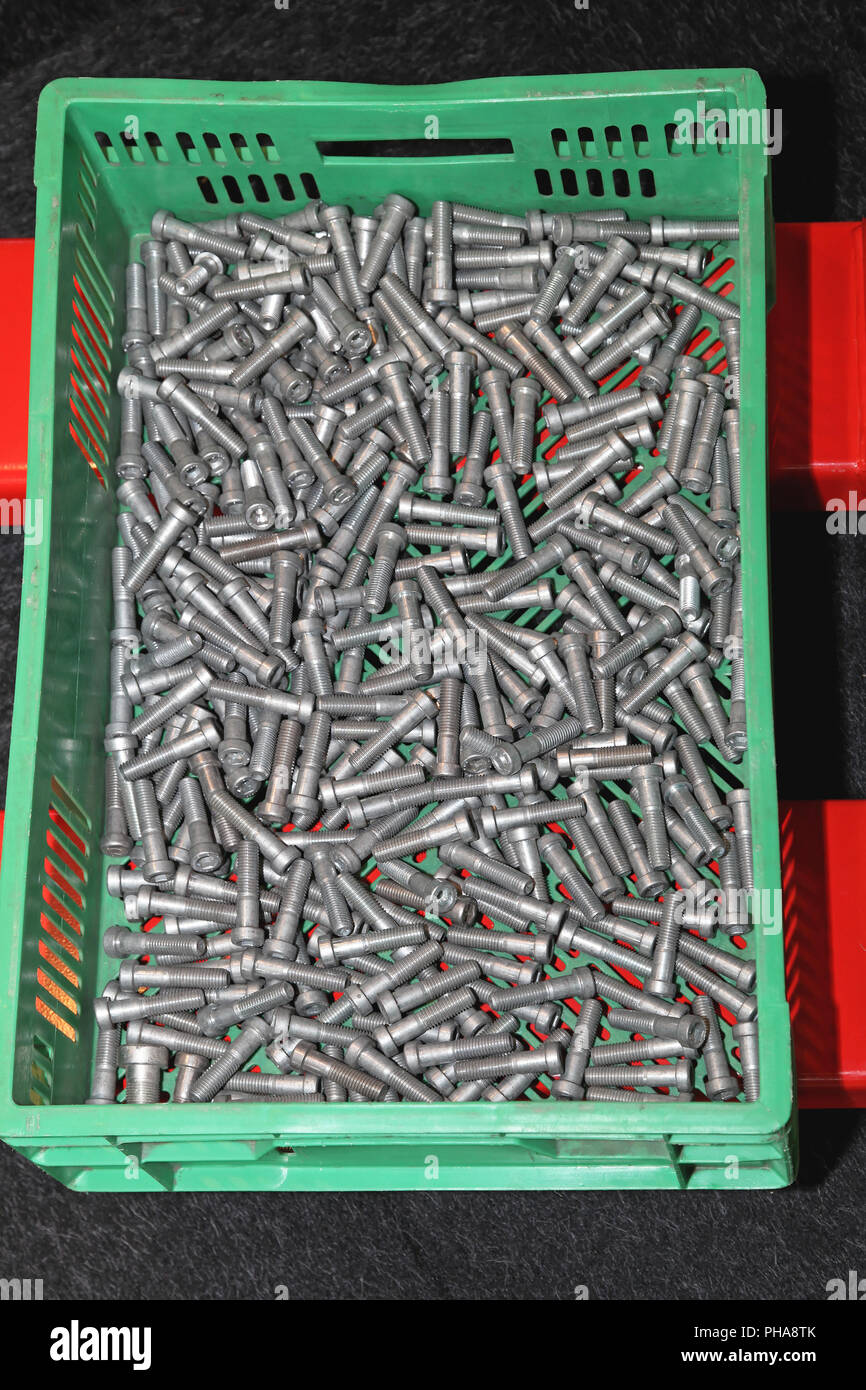 Crate with hex socket machine metal bolts Stock Photo - Alamy