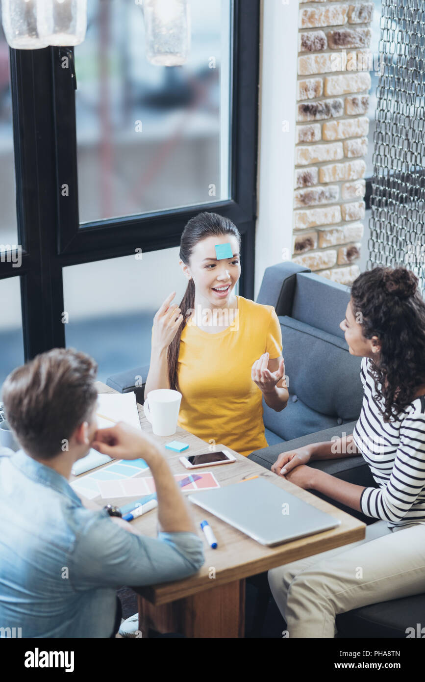 Attractive three friends guessing characters Stock Photo - Alamy