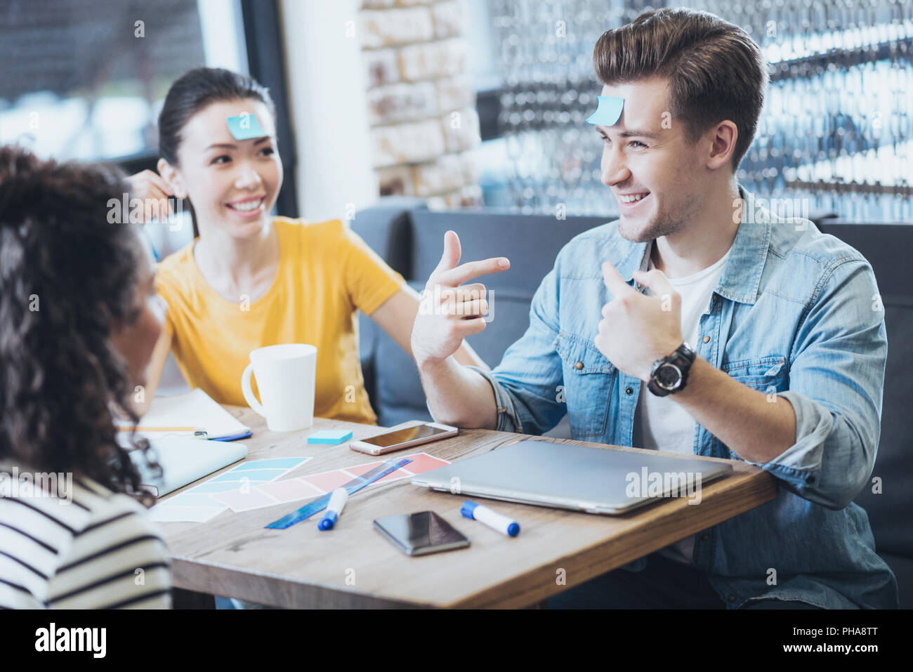 Happy three friends engaging in game Stock Photo - Alamy