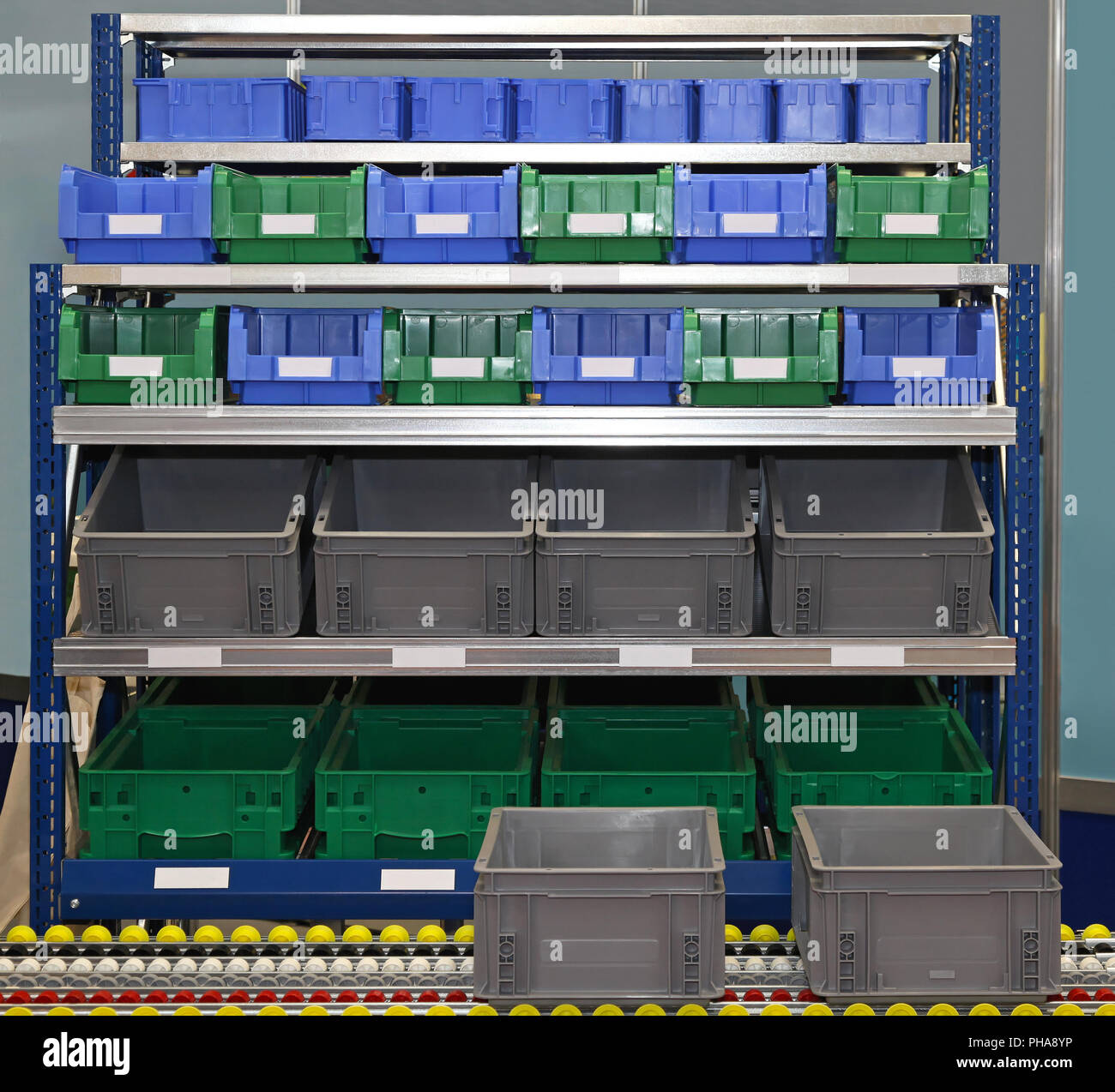 Logistic boxes and conveyor rollers in distribution warehouse Stock ...