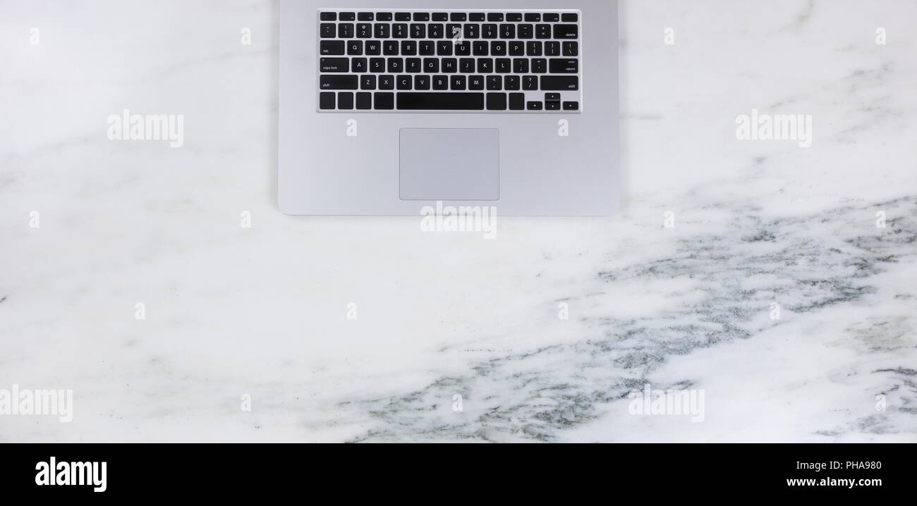 Marble desktop setting with modern mobile laptop computer Stock Photo ...