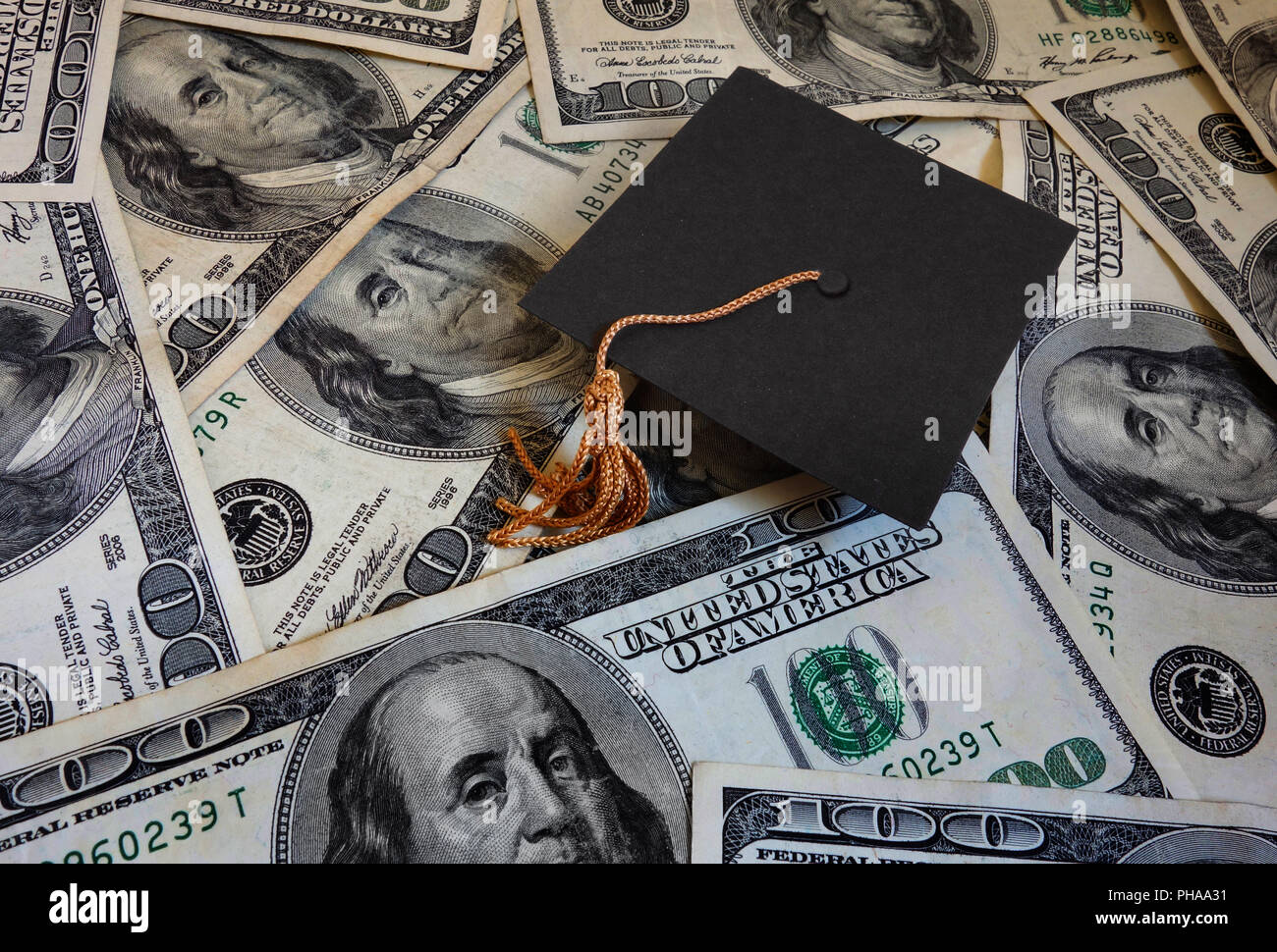 Graduation cap on money Stock Photo - Alamy